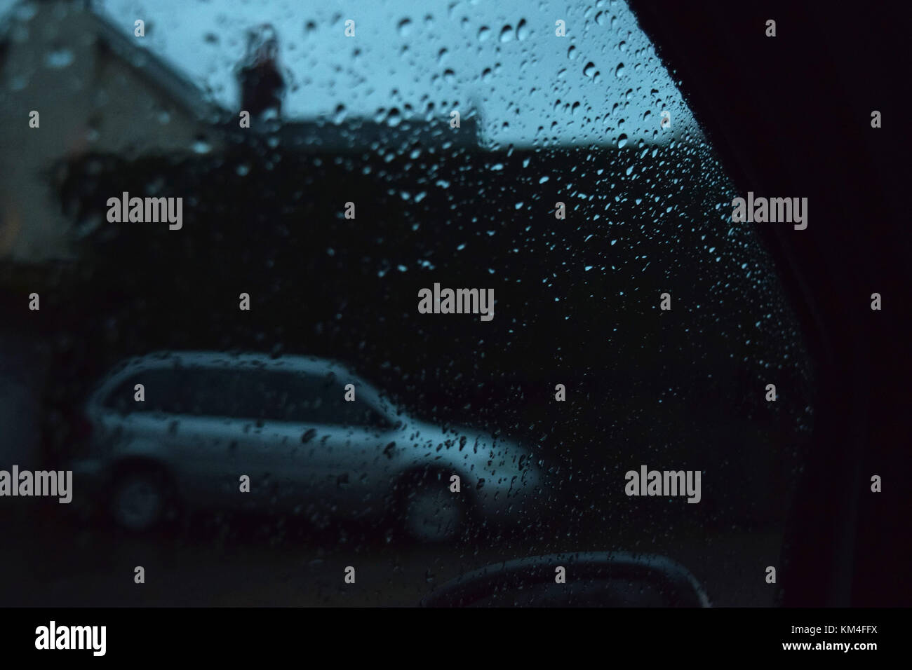 Street lights captured through a rain covered window with the focus ...