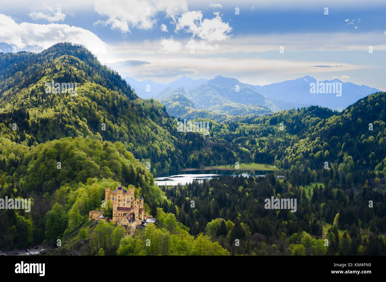 Panorama of the Alpsee lake and its forest, under a partially cloudy ...