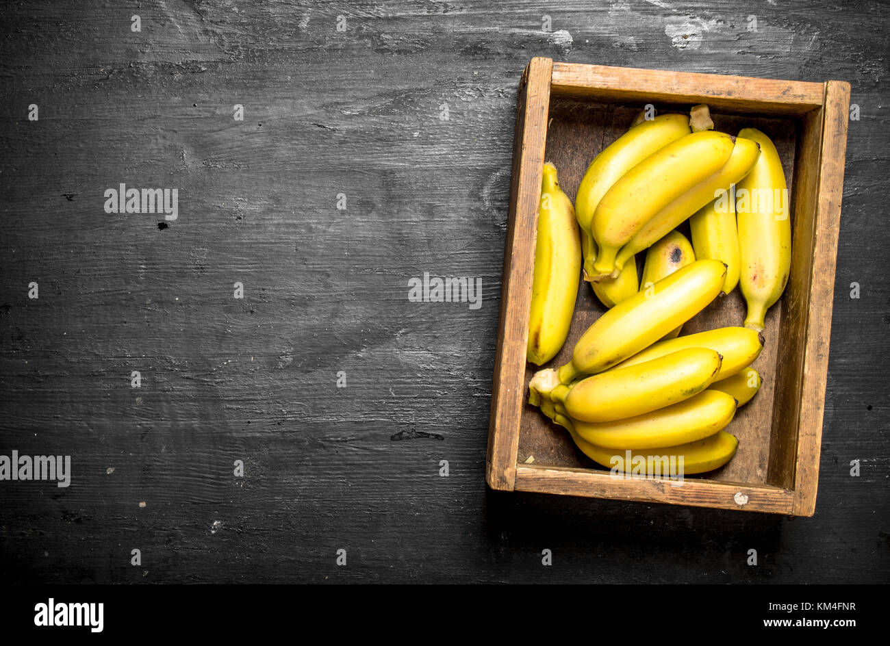 Fresh bananas in an old box. On a black chalkboard Stock Photo - Alamy