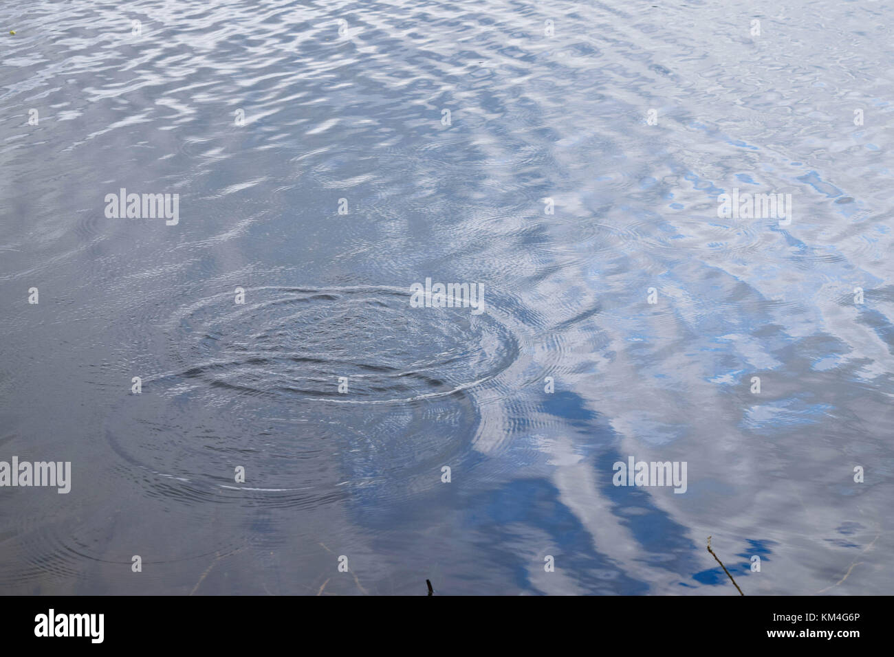 Reflection and ripples caught on the surface of a lake Stock Photo - Alamy