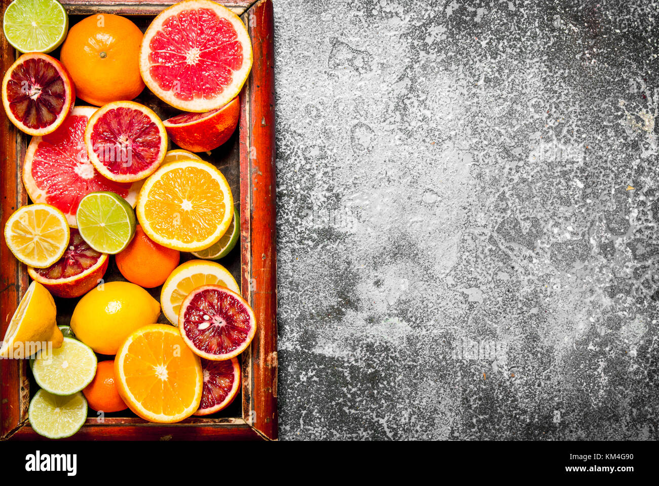 Citrus background. Citrus fruits in the old tray. On rustic background ...