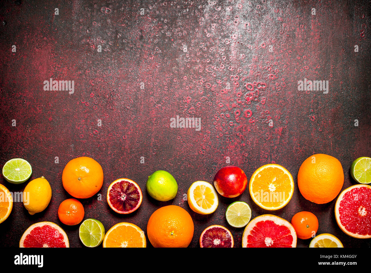 Citrus background. Citrus fruits . On rustic red background Stock Photo ...