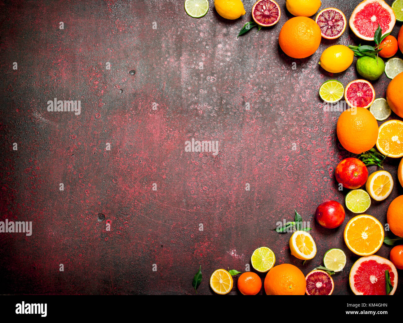 Citrus background. Citrus fruits . On rustic red background Stock Photo ...