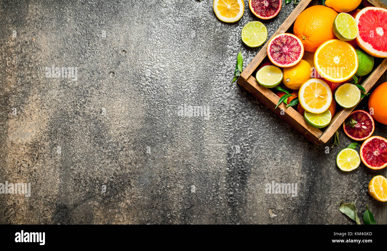 Citrus background. Fresh citrus fruit in an old box. On rustic ...