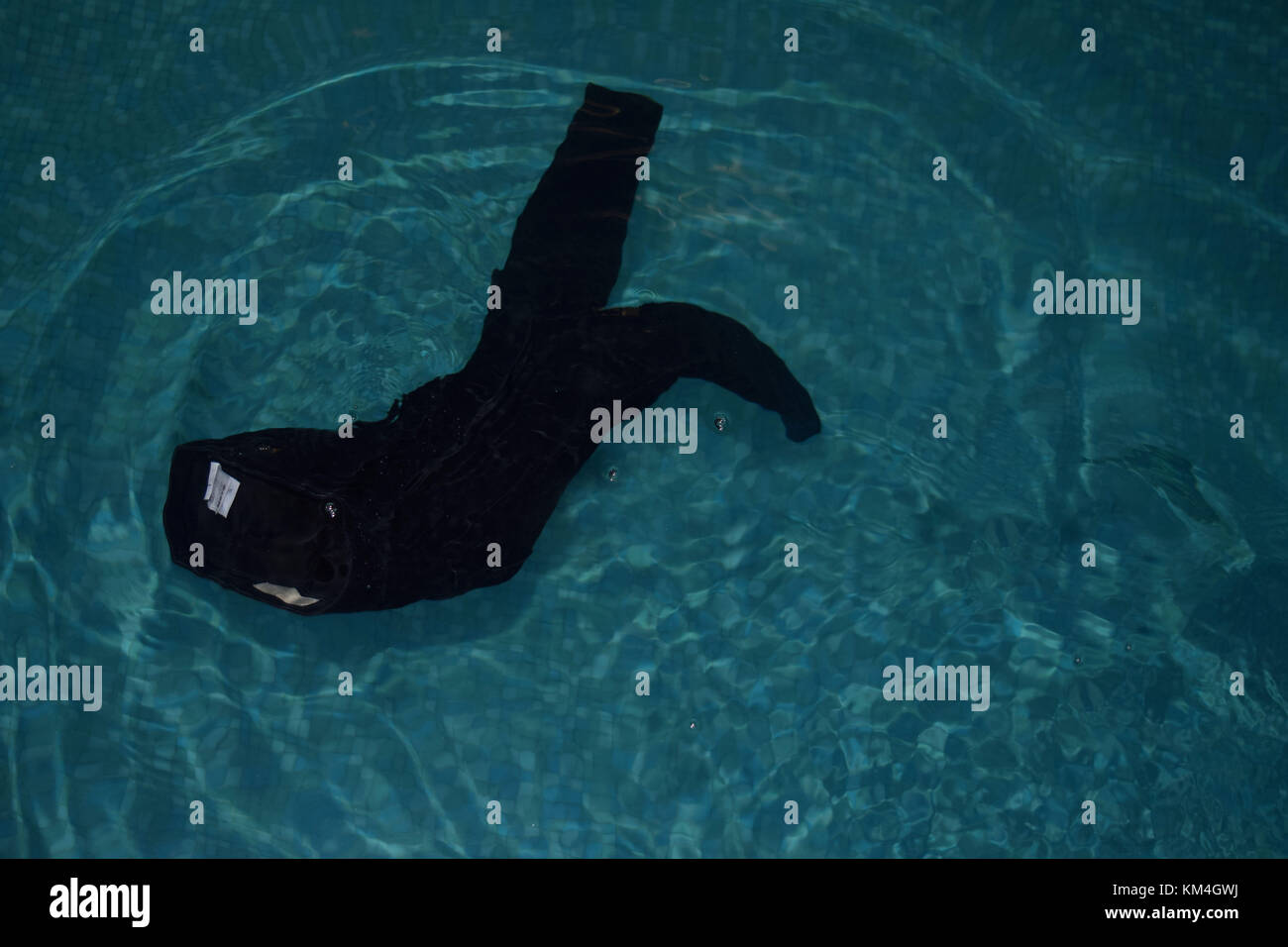 Clothes sinking in a swimming pool to represent the people that have ...