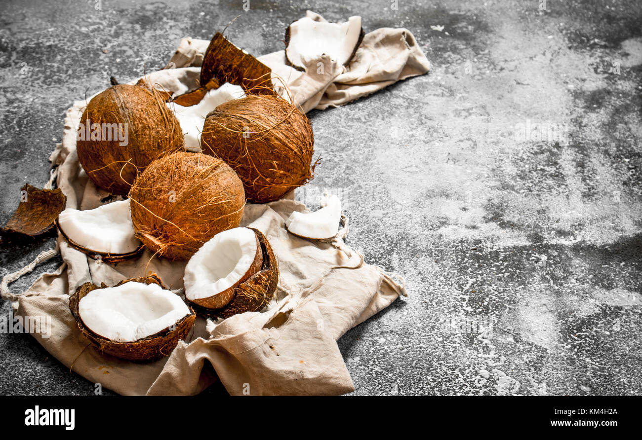 Fresh coconuts on the old fabric. On rustic background Stock Photo - Alamy