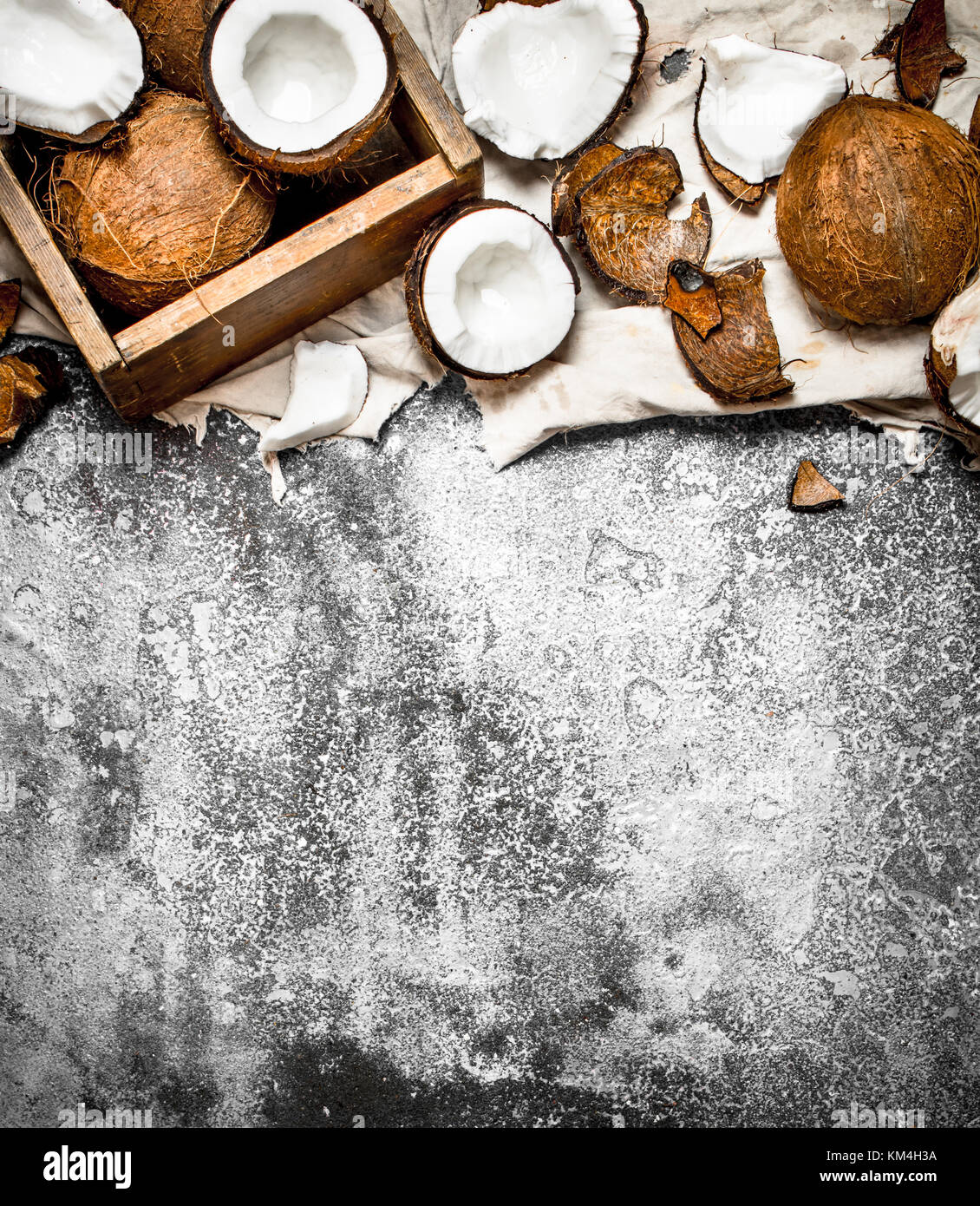 Fresh coconuts in an old box on the fabric. On rustic background Stock ...
