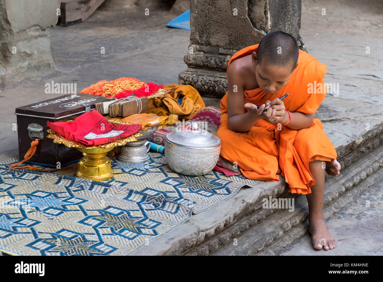 Young monk writing on his hand, Angkor Wat, Cambodia Stock Photo - Alamy