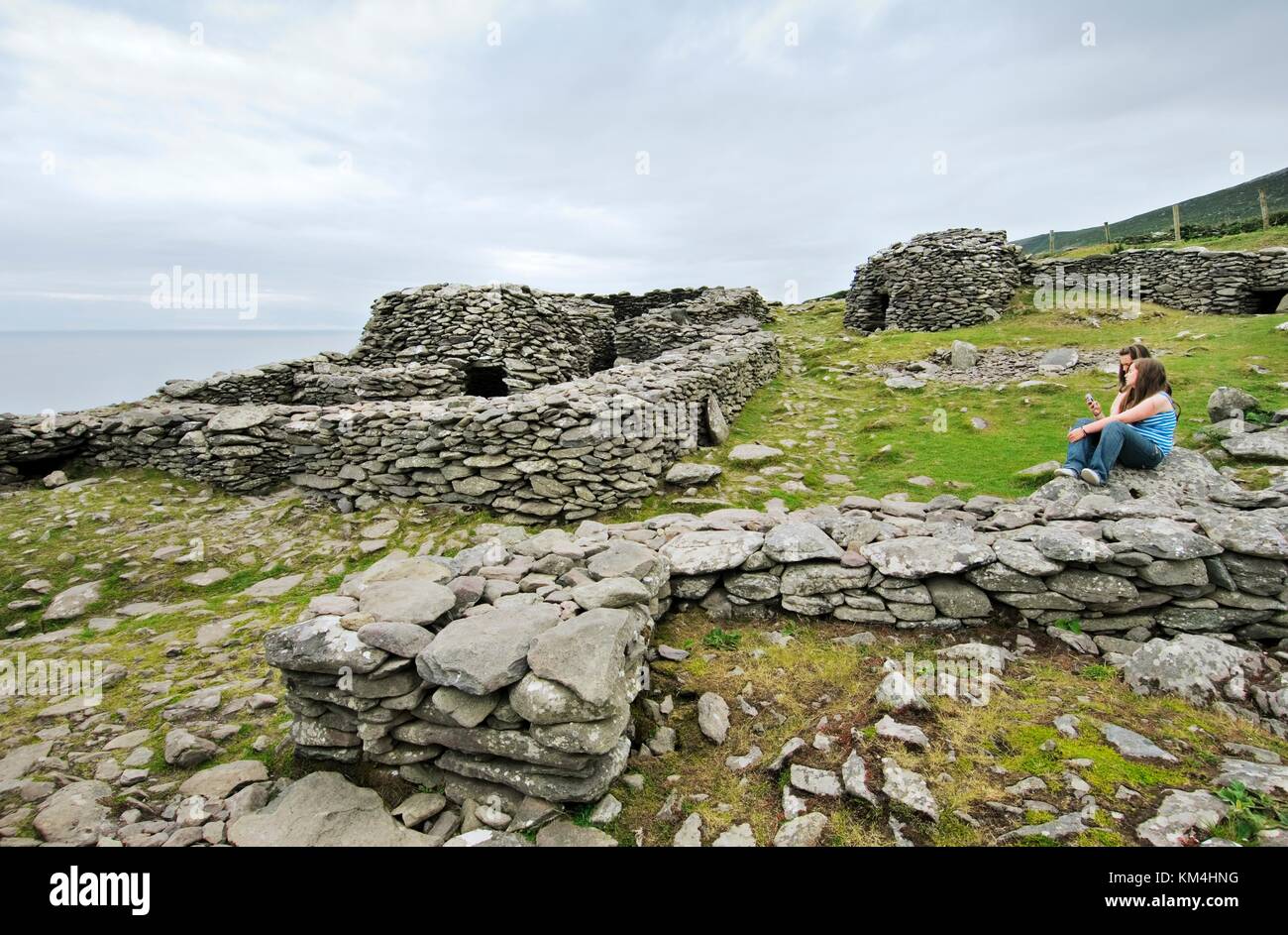 Ancient Celtic stone houses in walled enclosure settlement or cashel of ...