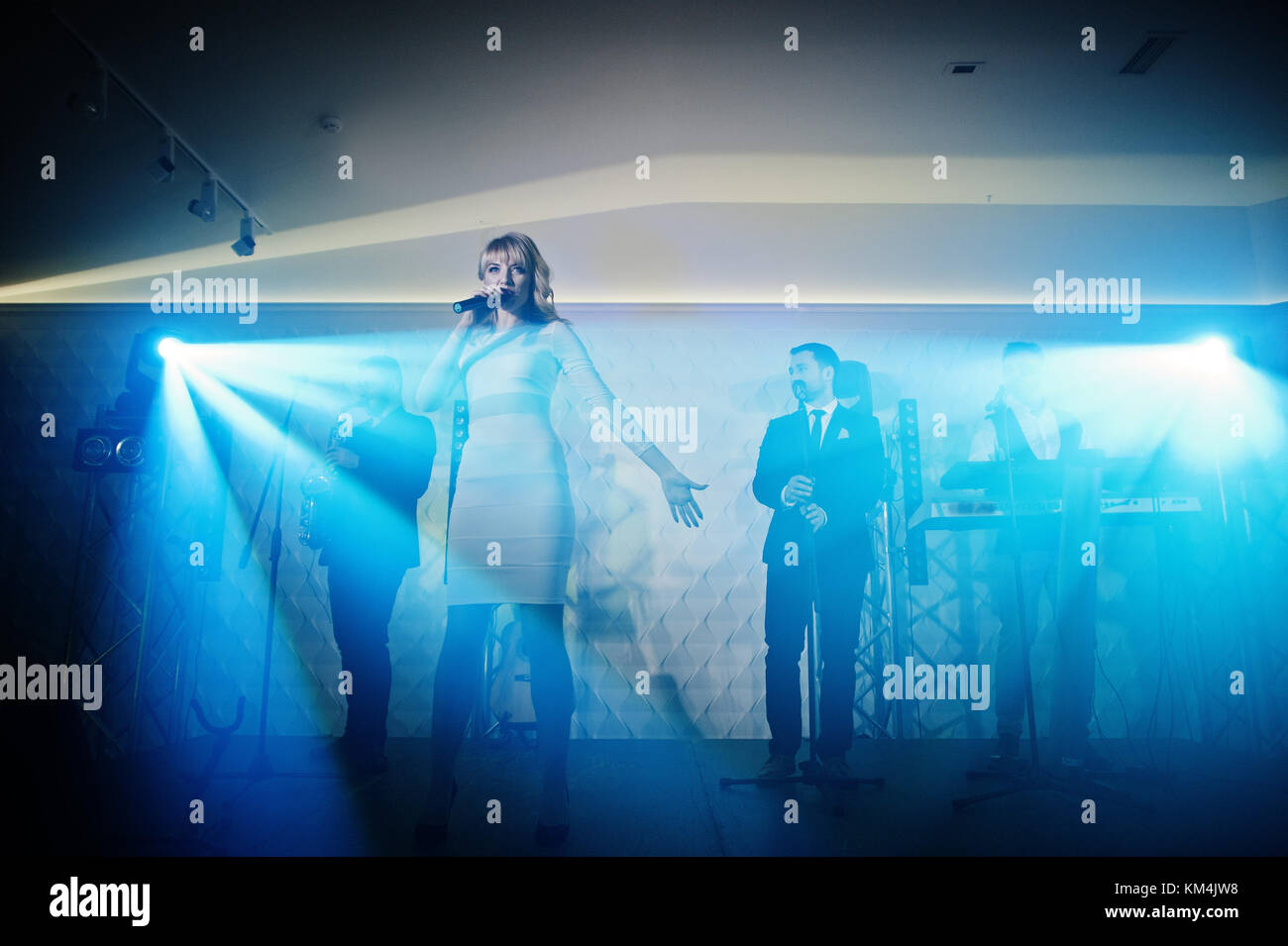 Musicial music live band performing on a stage with different lights ...