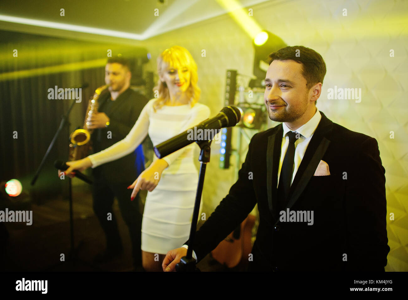 Musicial music live band performing on a stage with different lights ...