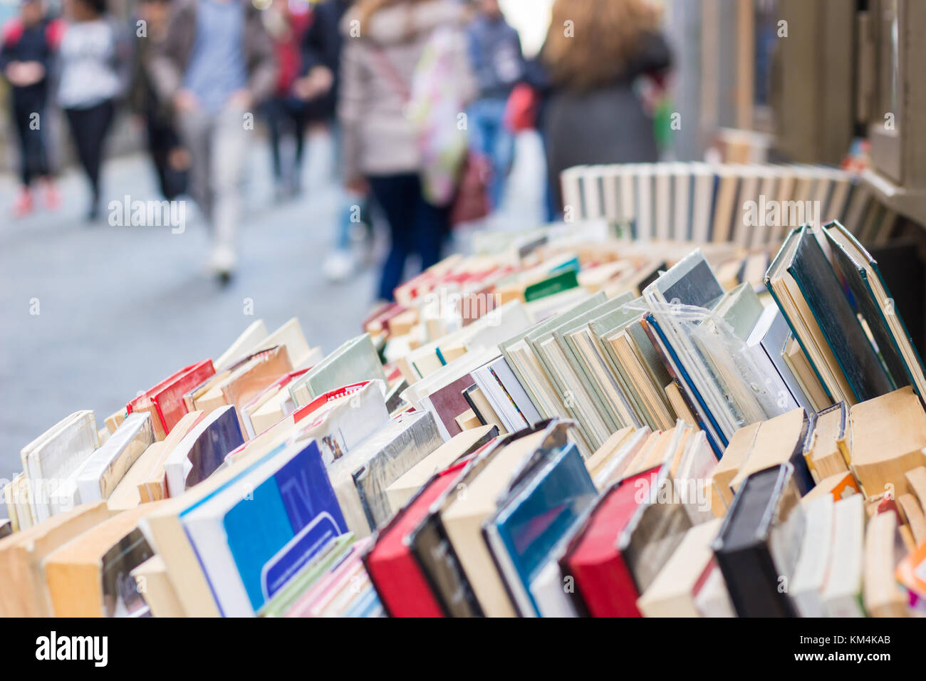 Colorful old second hand books display on a stand, in a street of ...