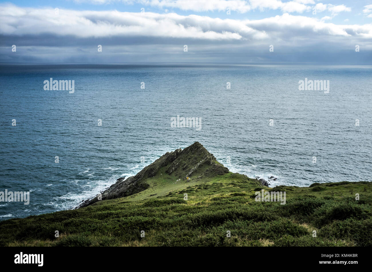 The view from above of a sharp ridge and steep hillside on a headland ...