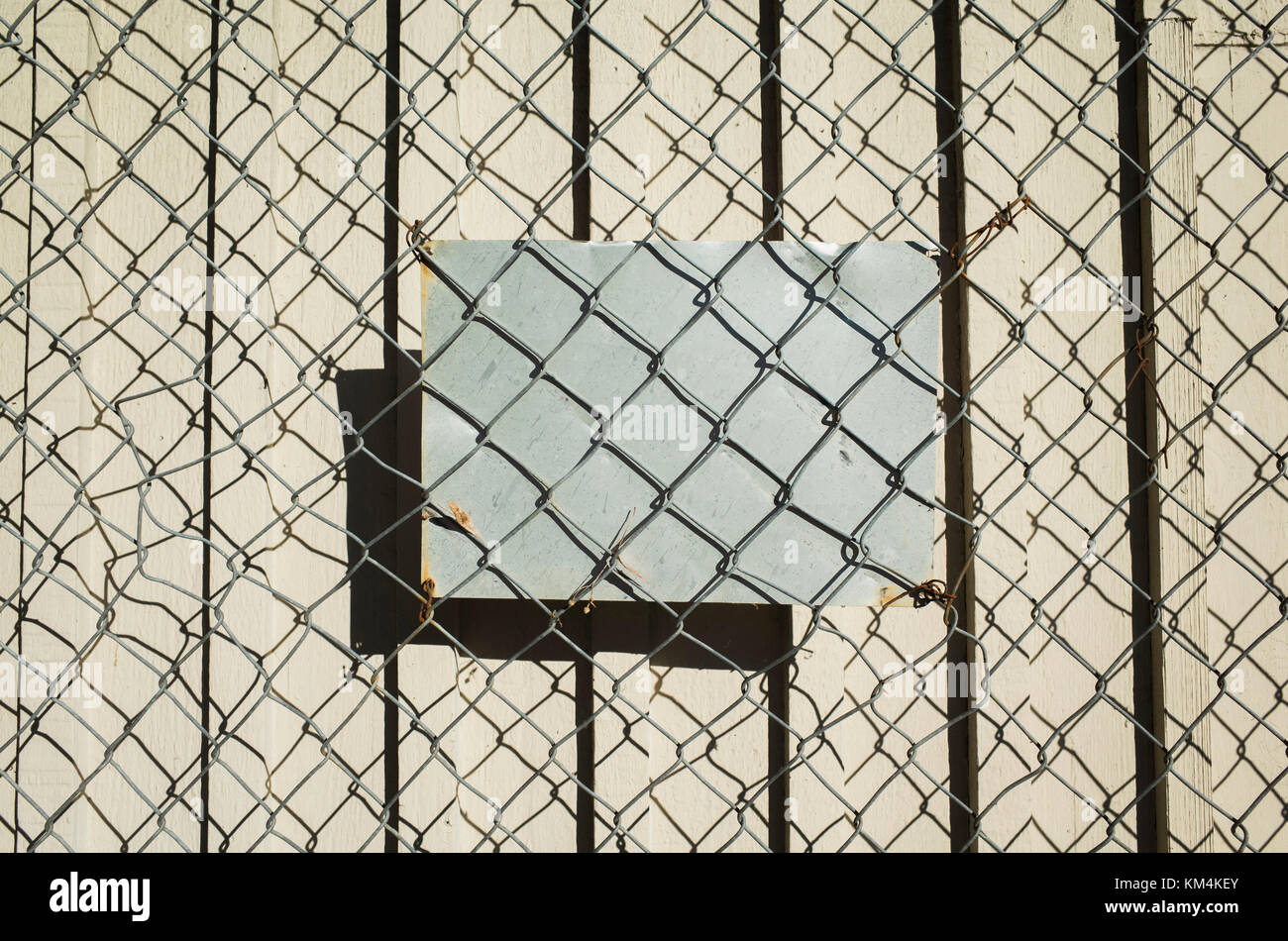 Close up detail of chainlink fence and metal sign Stock Photo - Alamy