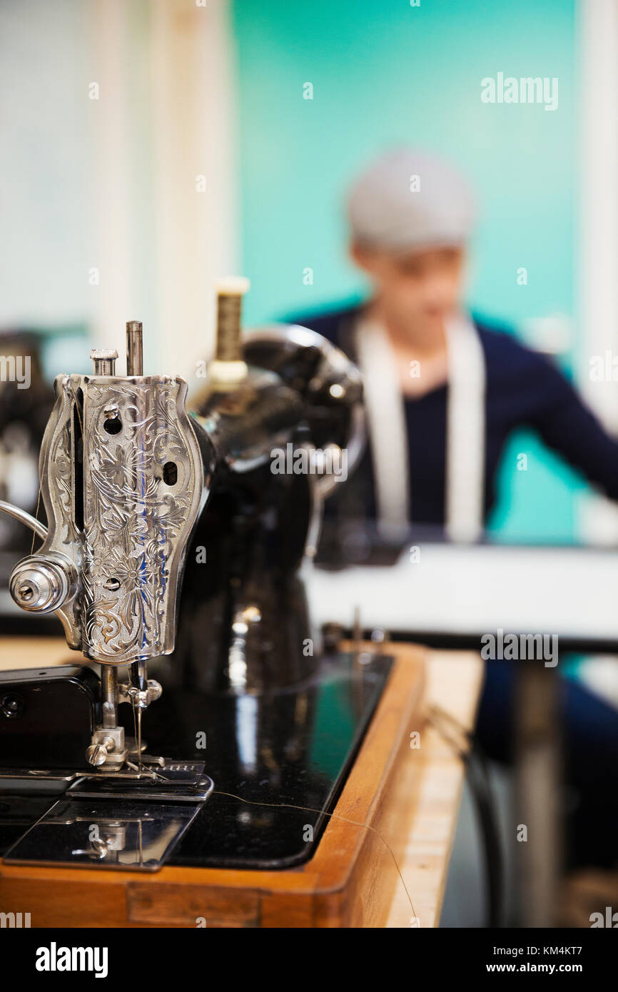 A retro style traditional sewing machine with chased metalwork, and a ...