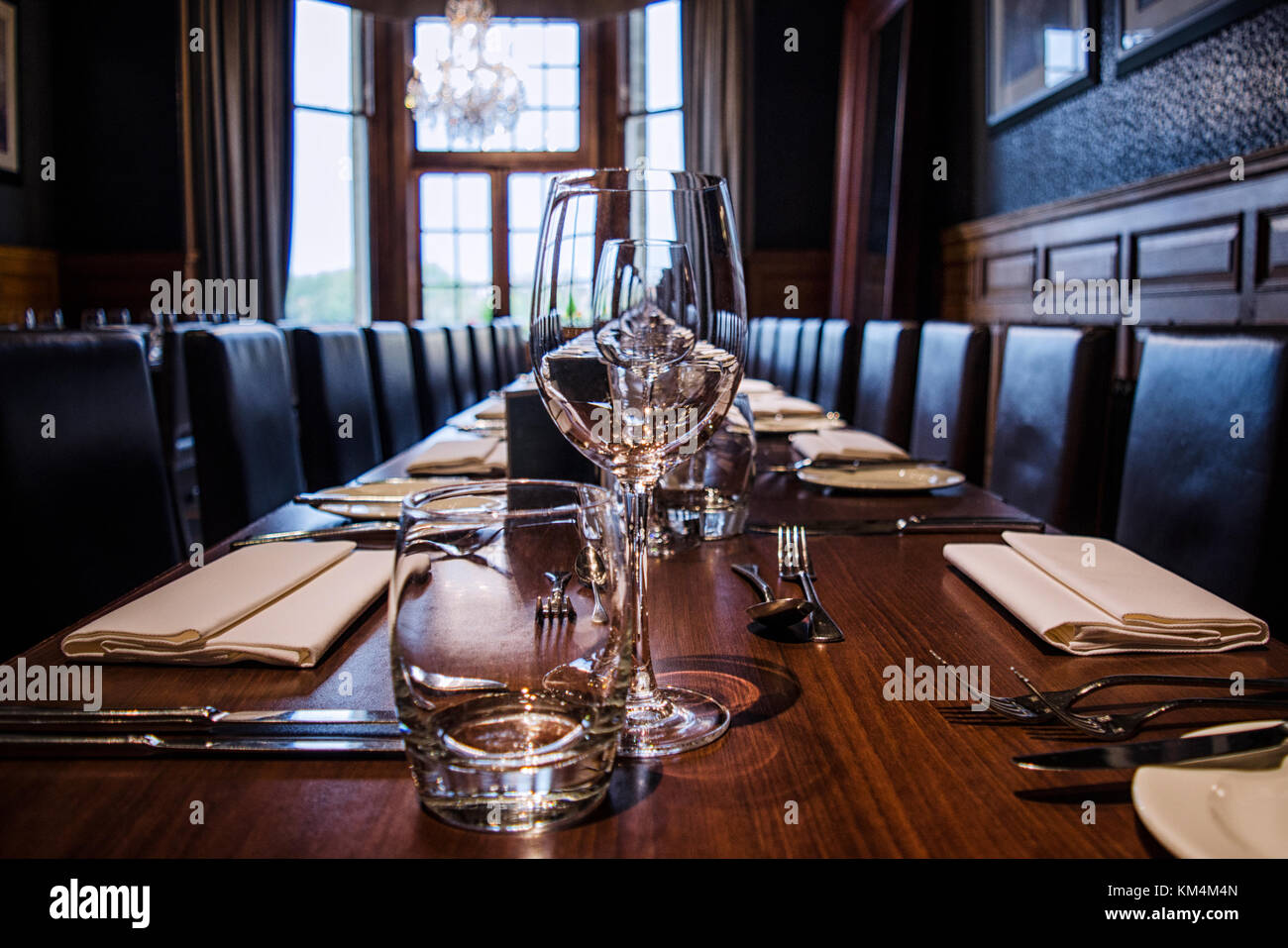 Long Dinner Table Setting Looking Through Wine Glass Stock Photo - Alamy
