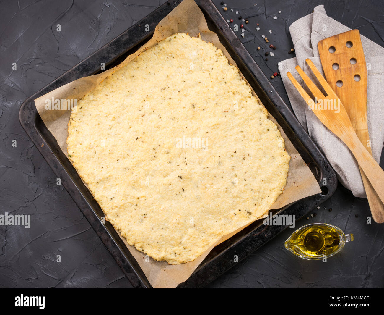 Top view of homemade cauliflower pizza crust dough in dripping pan on ...