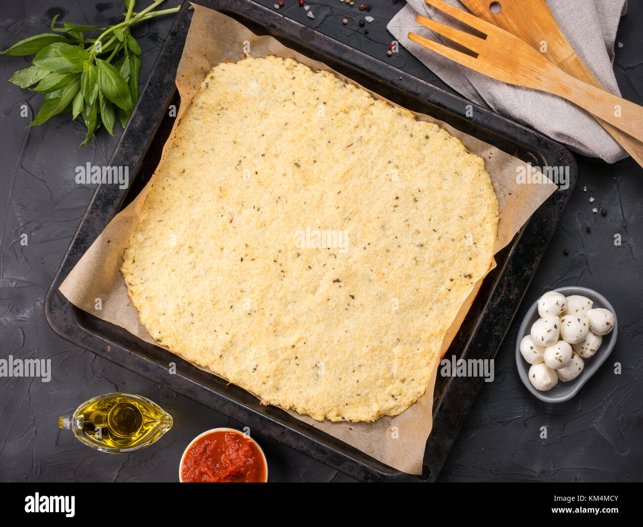 Top view of homemade cauliflower pizza crust dough in dripping pan with ...