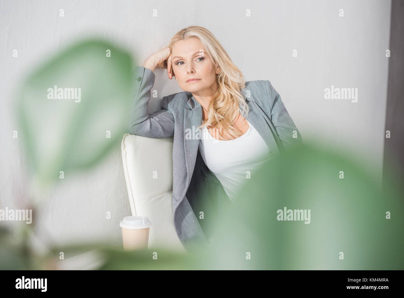 businesswoman with coffee in waiting room Stock Photo - Alamy
