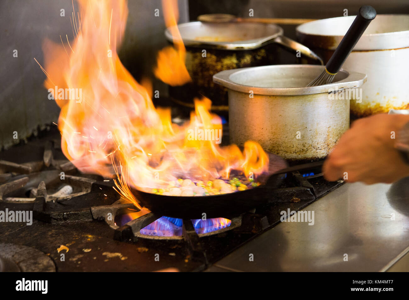 Flaming frying pan in restaurant kitchen Stock Photo - Alamy