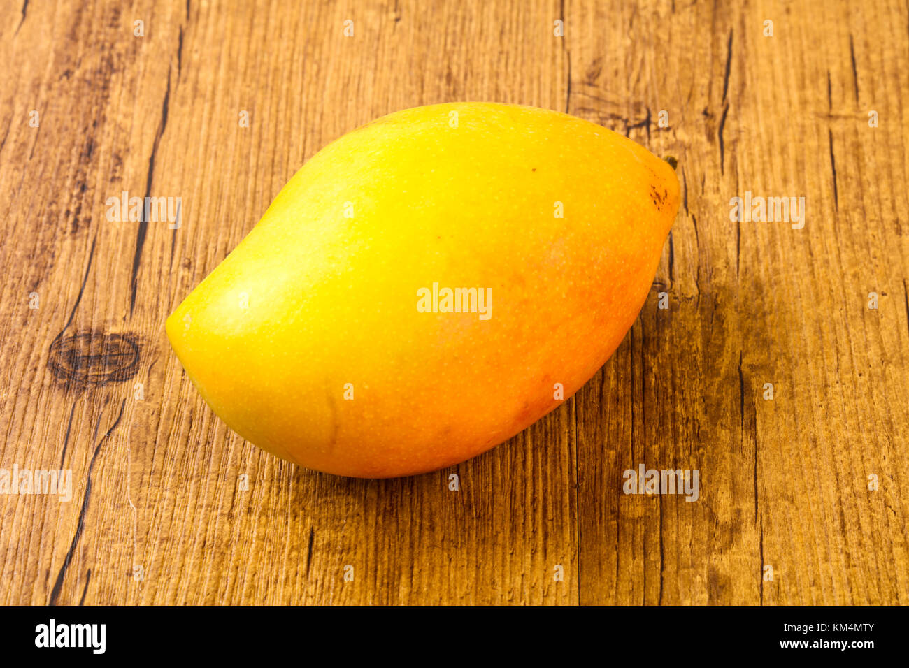 Sweet mango fruit over the wooden background Stock Photo - Alamy