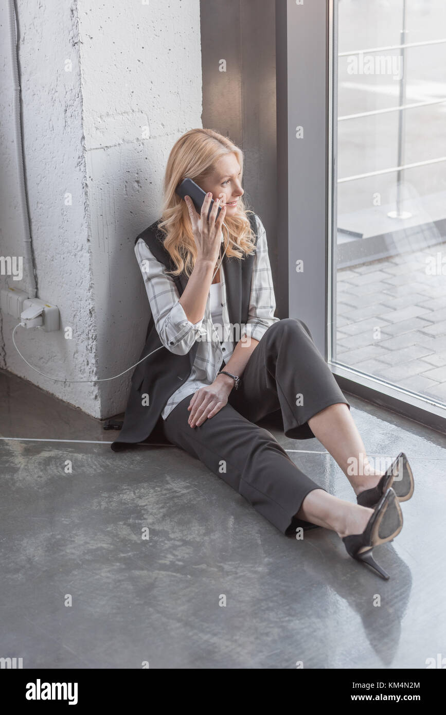 businesswoman charging smartphone and making call Stock Photo - Alamy