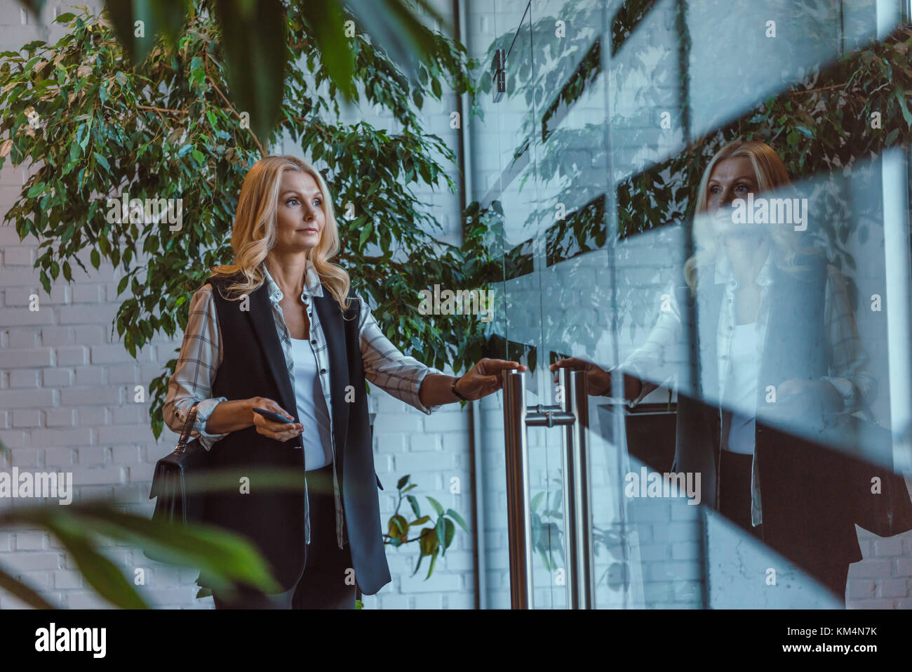 woman going out of office Stock Photo - Alamy