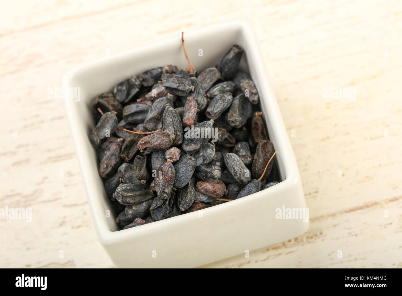 Dry barberry in the bowl over wooden background Stock Photo - Alamy