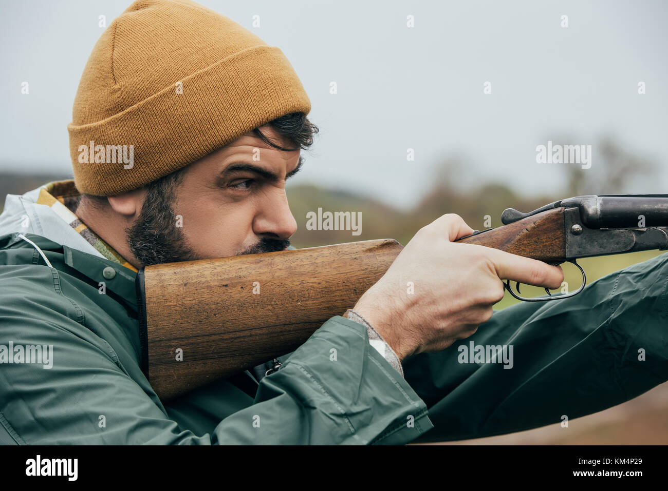 Handsome man aiming with gun Stock Photo - Alamy
