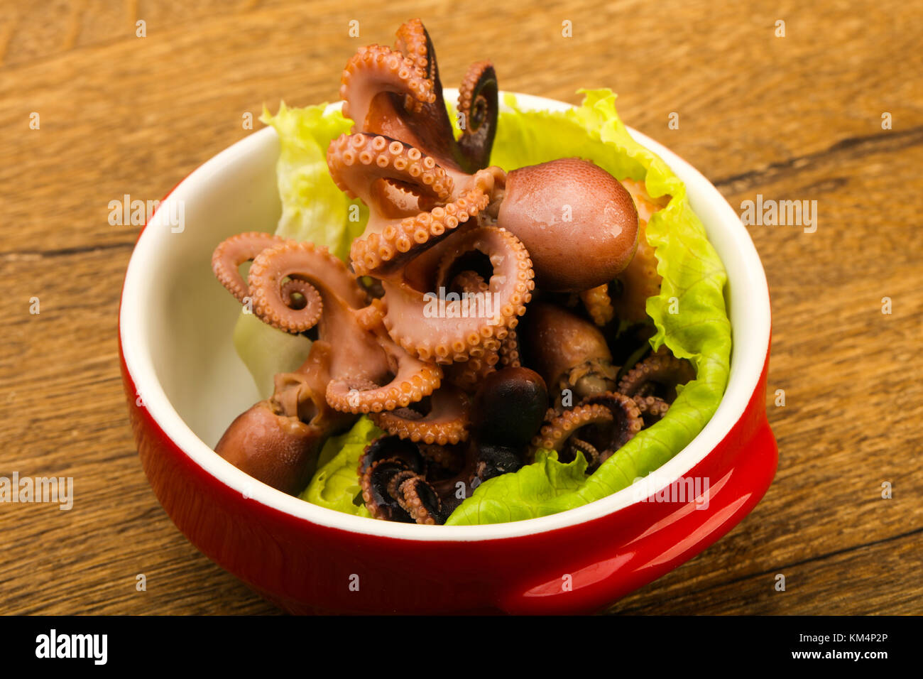 Boiled baby octopuses over salad leaves Stock Photo - Alamy