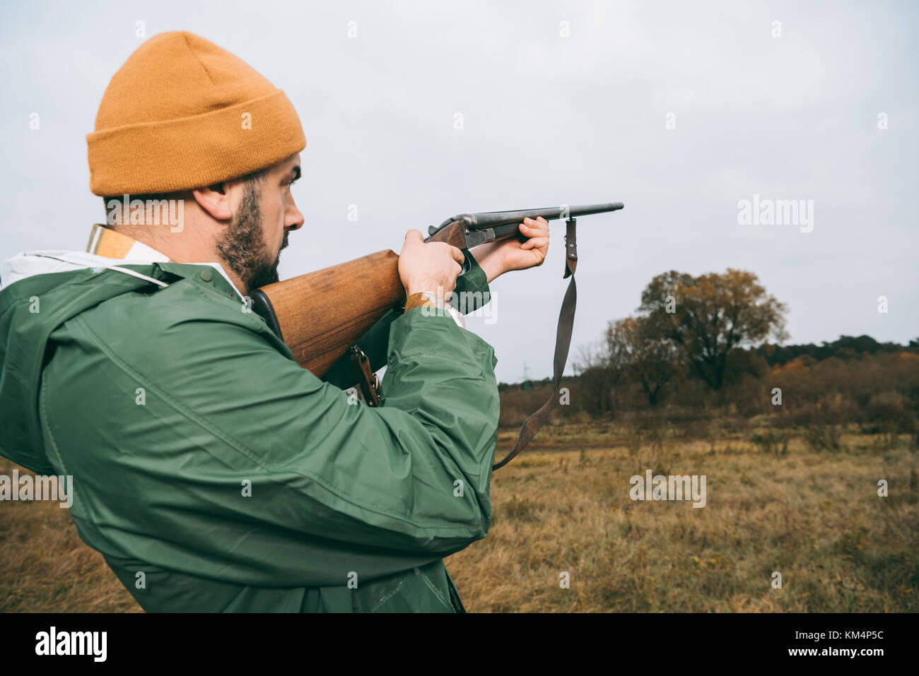 hunter aiming at something with gun Stock Photo - Alamy