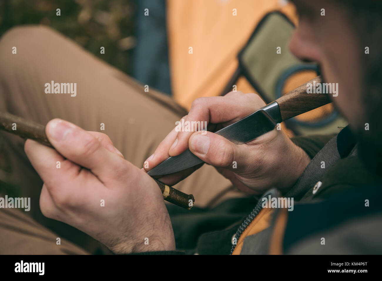 man sharpening branch Stock Photo - Alamy