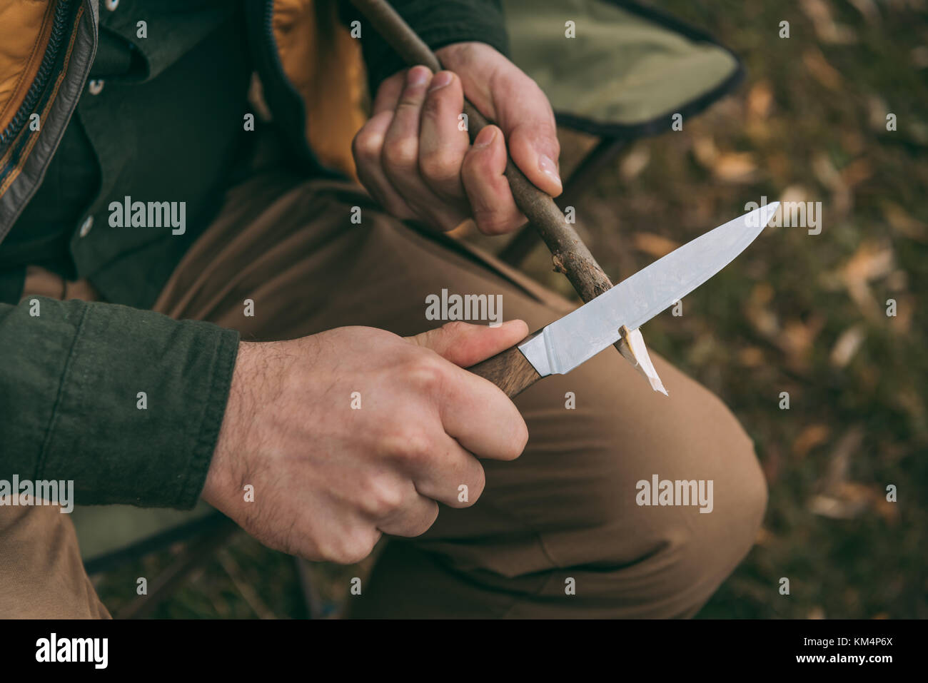 man sharpening branch Stock Photo - Alamy