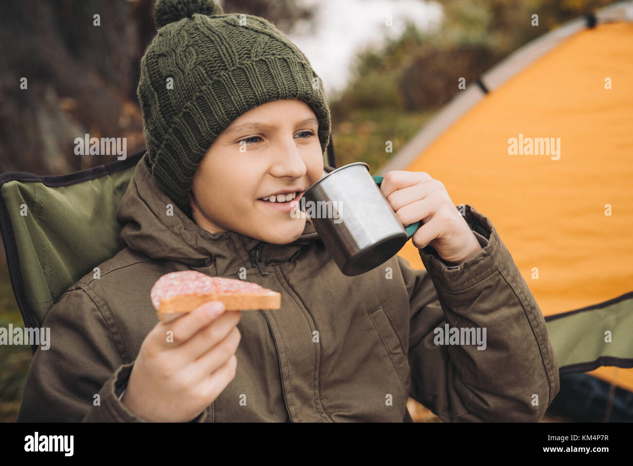 boy drinking tea and eating sandwich Stock Photo - Alamy