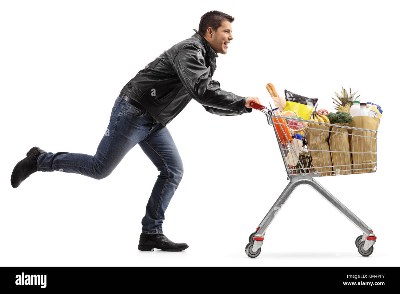 Full length profile shot of a biker running and pushing a shopping cart ...