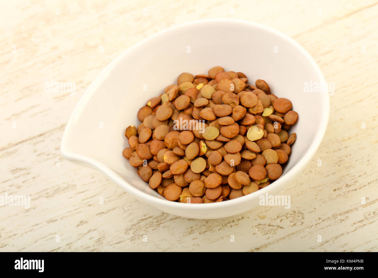 Raw lentils in the bowl ready for cooking Stock Photo - Alamy