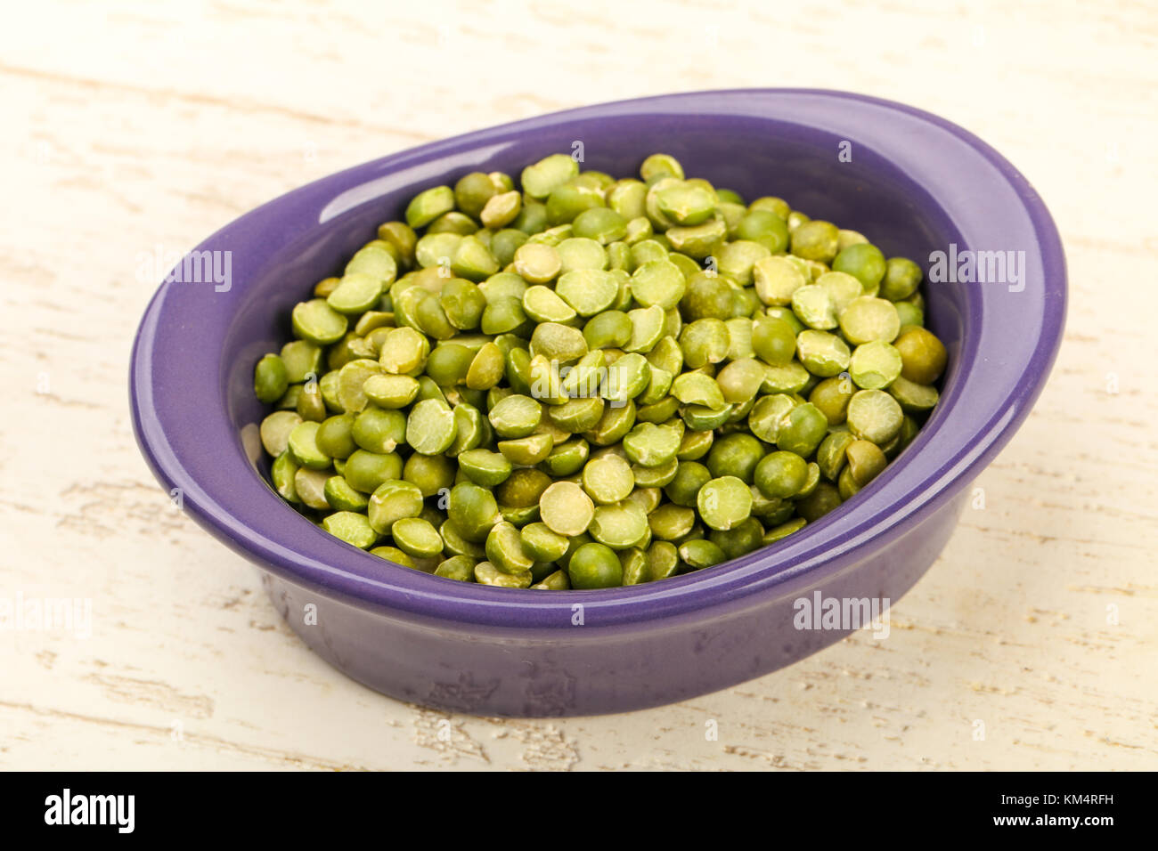 Green peas pile in the bowl over wooden background Stock Photo - Alamy