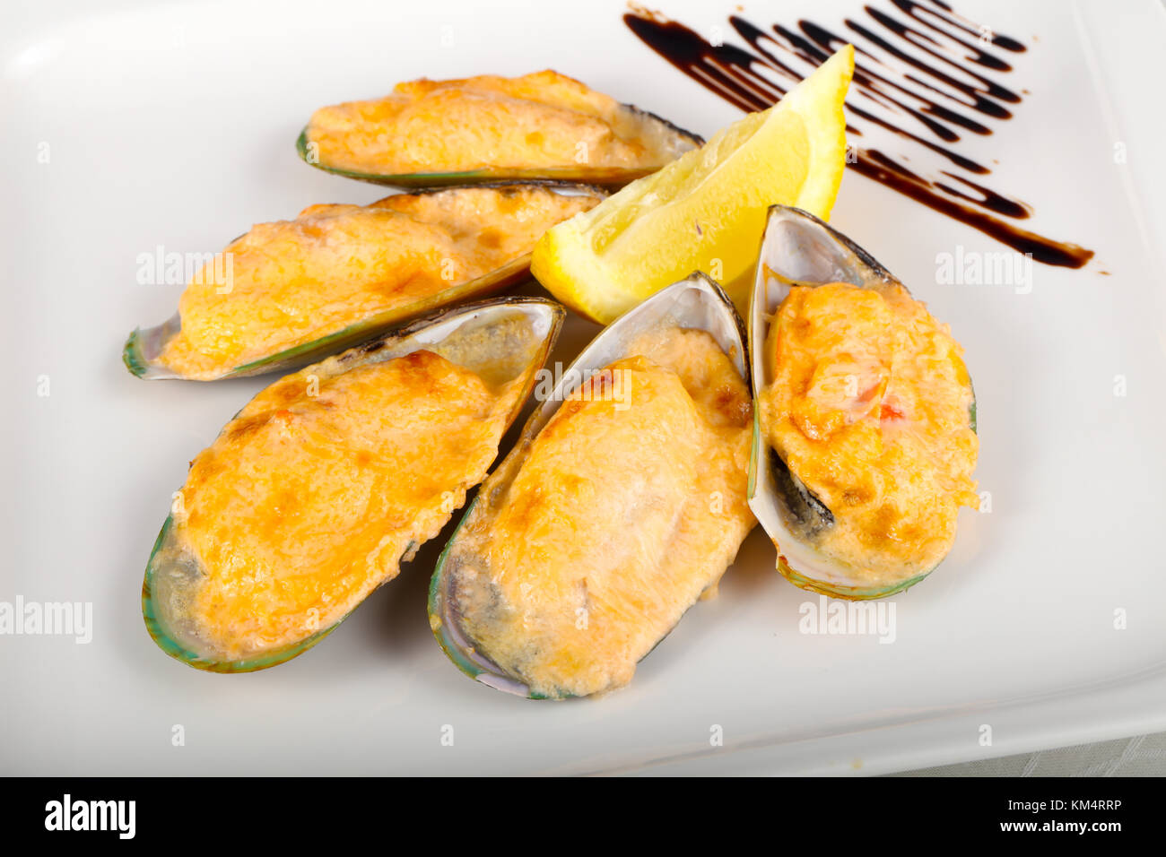 Baked mussels with cheese Stock Photo - Alamy