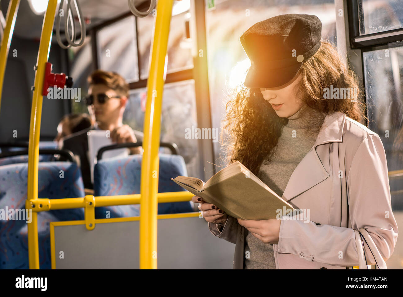 girl reading book in bus Stock Photo - Alamy