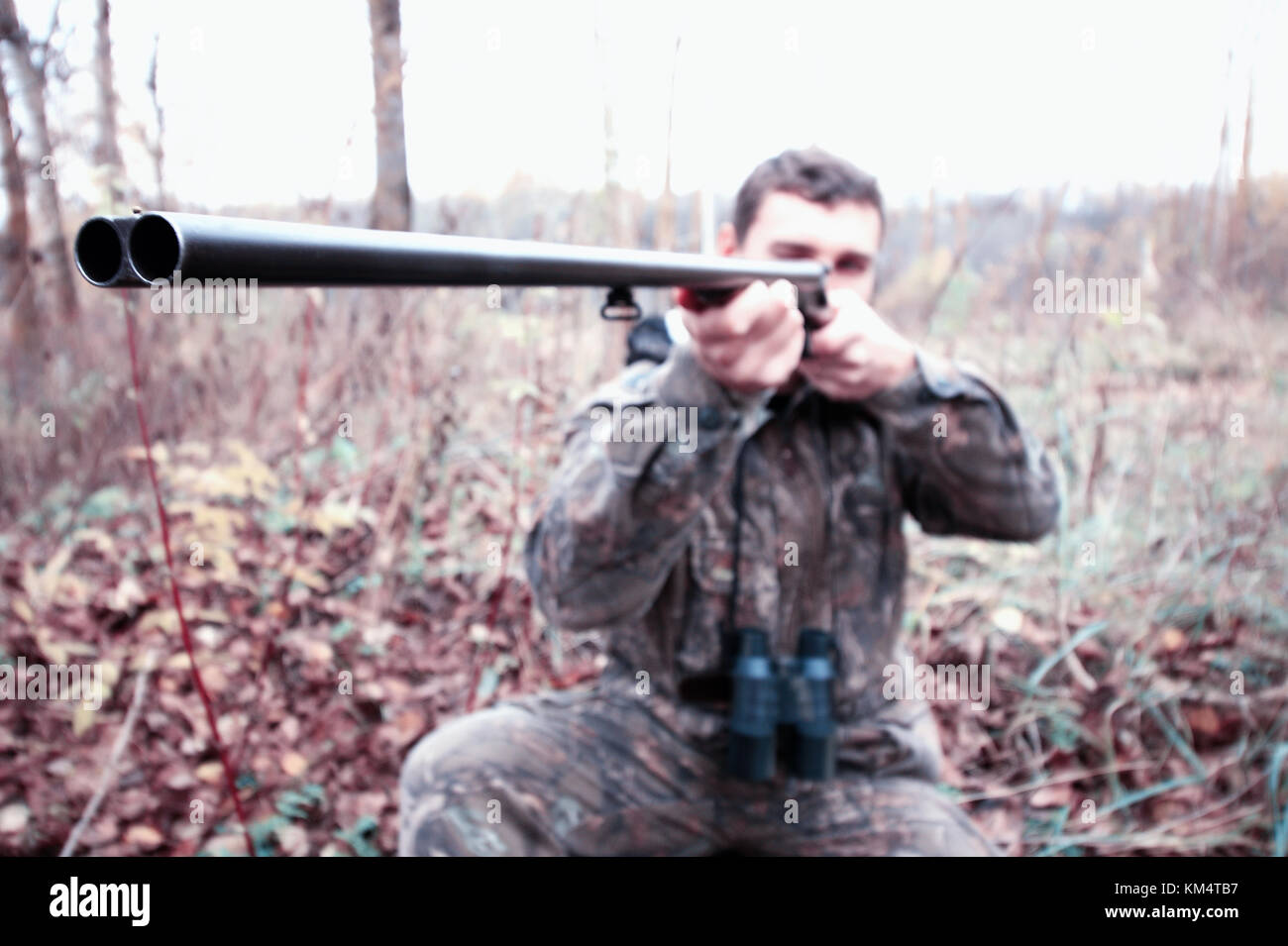 A man in camouflage and with a hunting rifle in a forest on a sp Stock ...