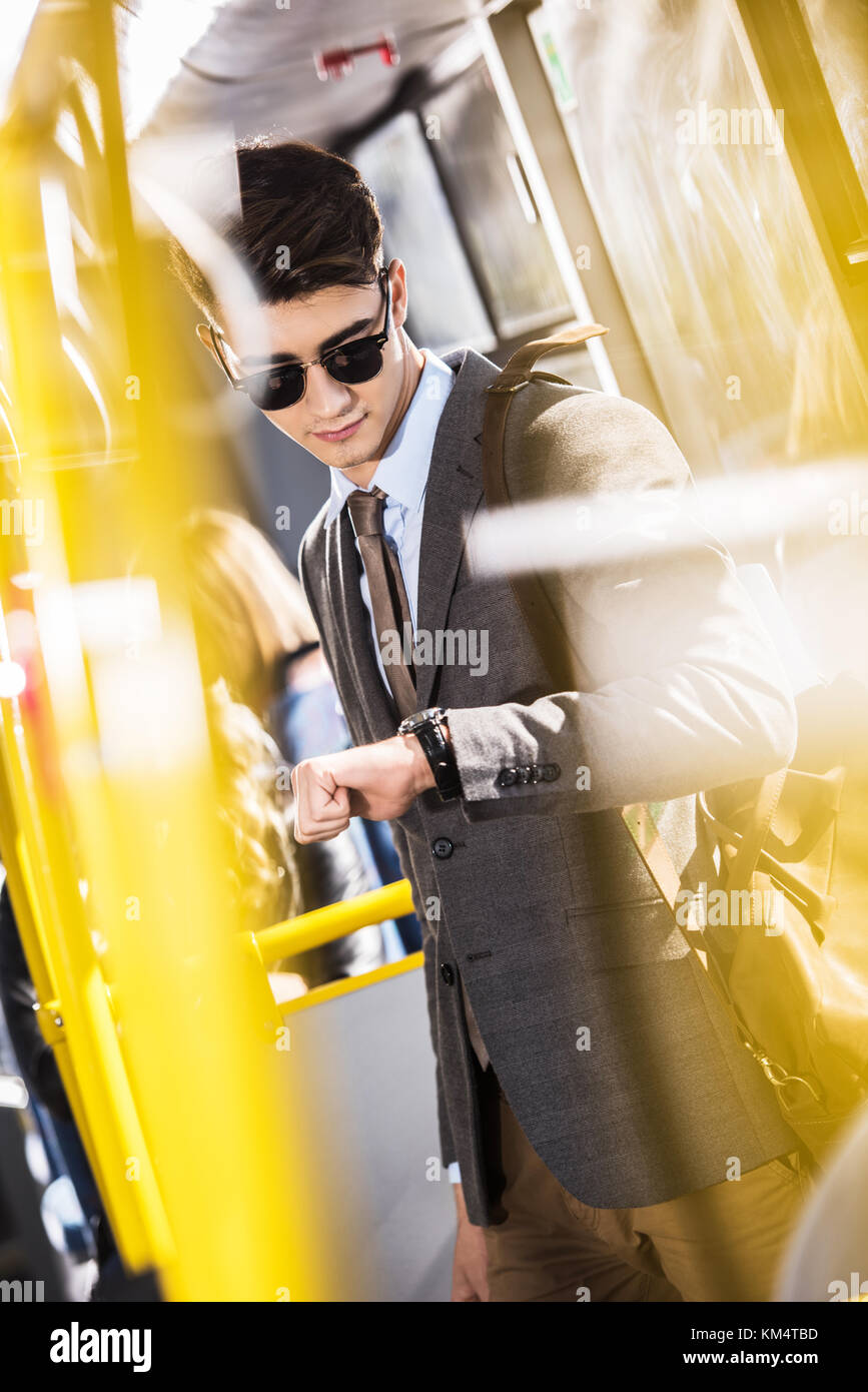 businessman checking wristwatch in bus Stock Photo - Alamy