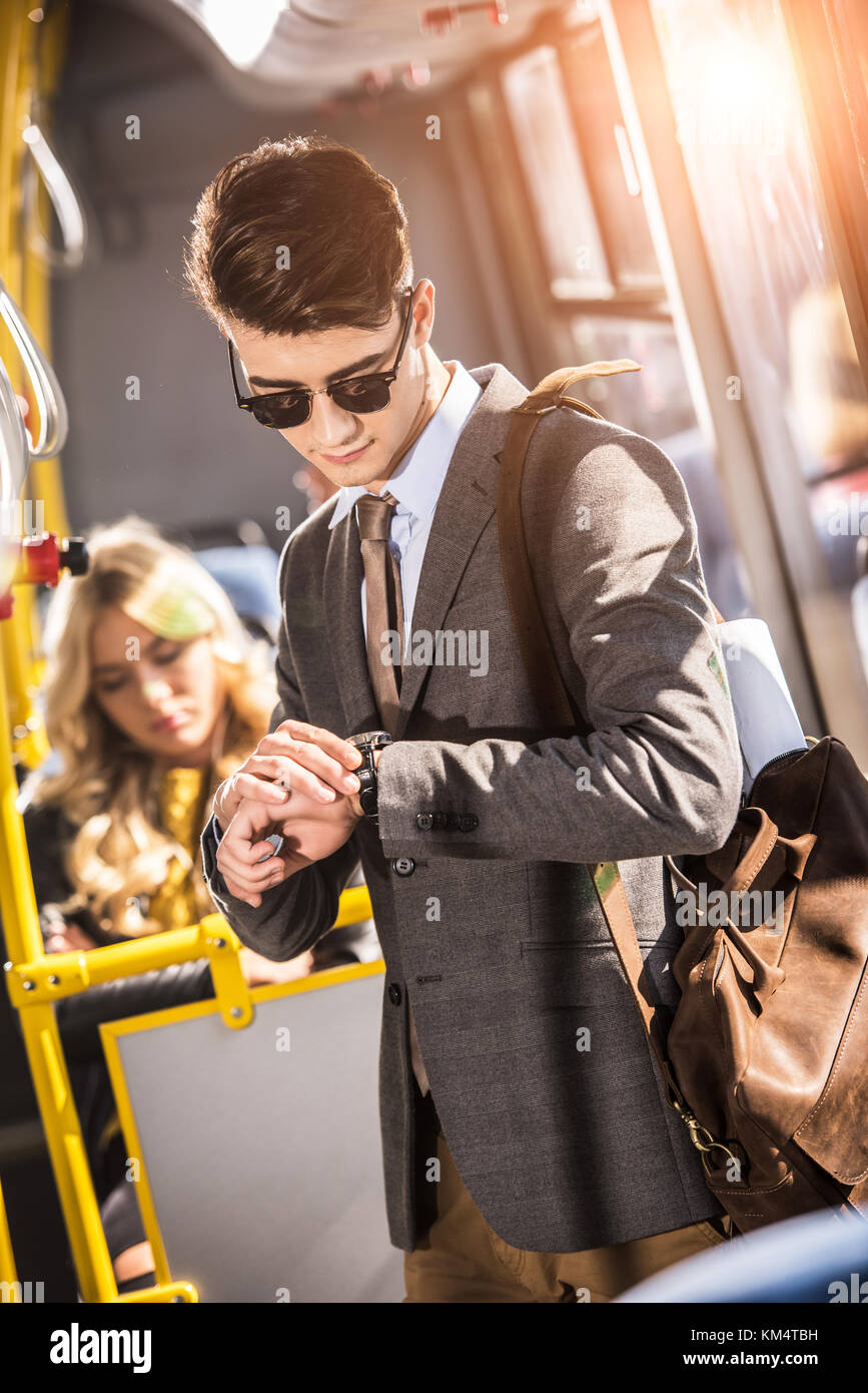 businessman checking wristwatch in bus Stock Photo - Alamy