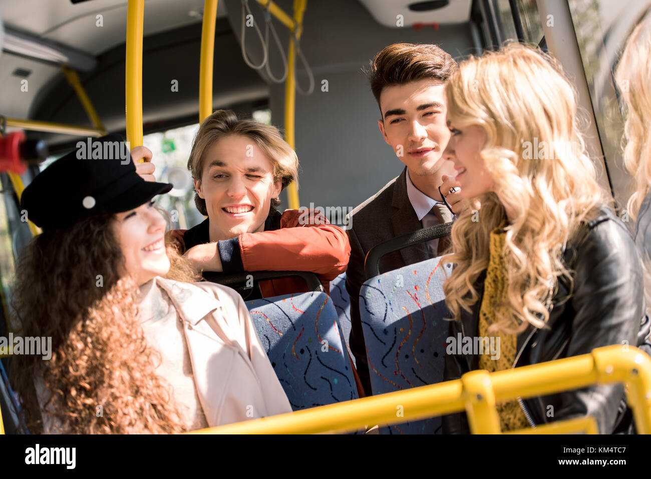 friends talking in bus Stock Photo - Alamy