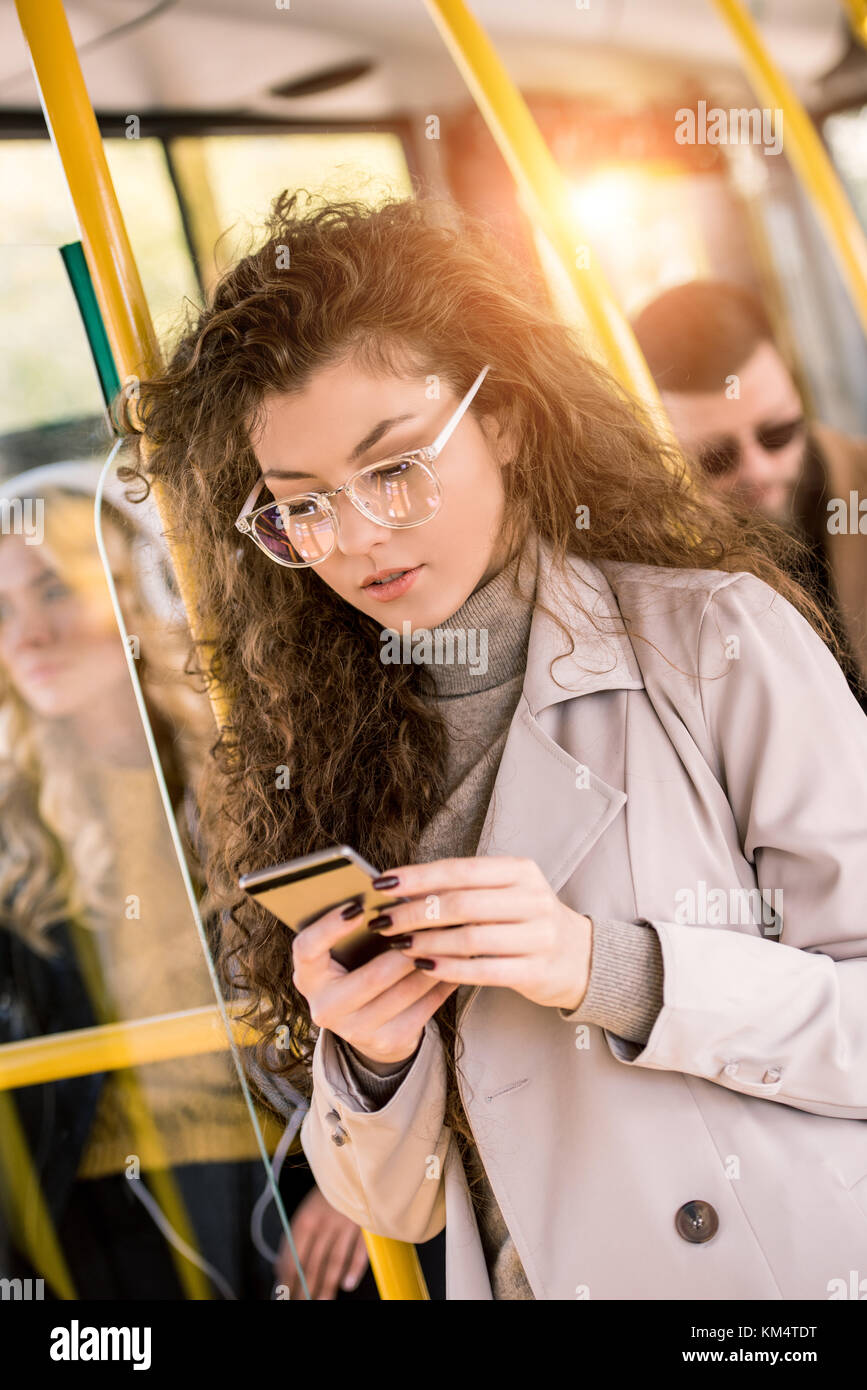 girl using smartphone in bus Stock Photo - Alamy