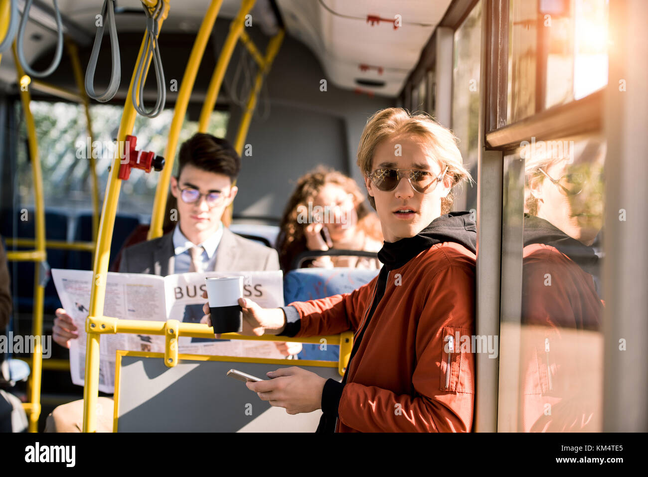man using smartphone in bus Stock Photo - Alamy