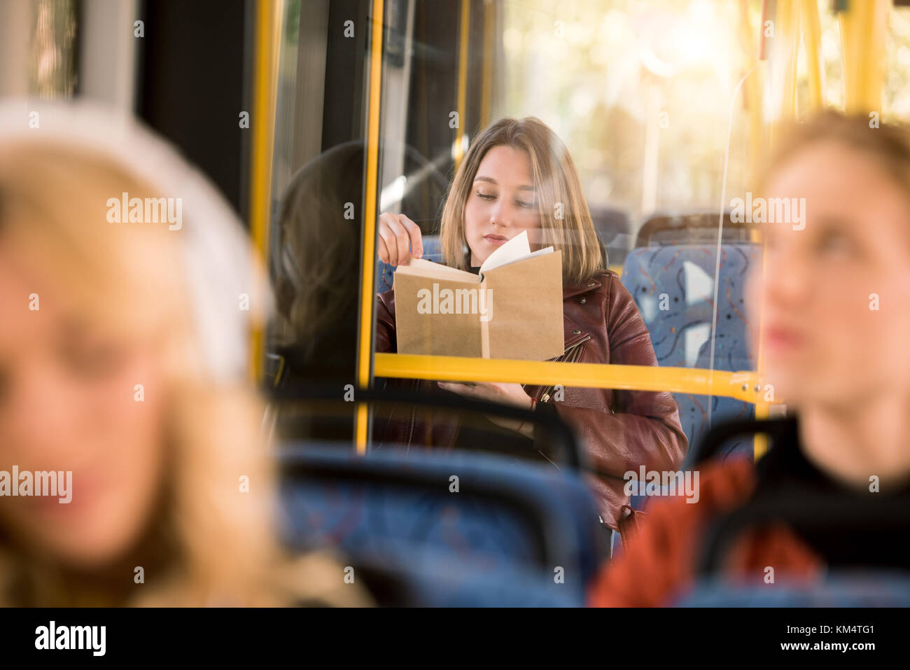 girl reading book in bus Stock Photo - Alamy