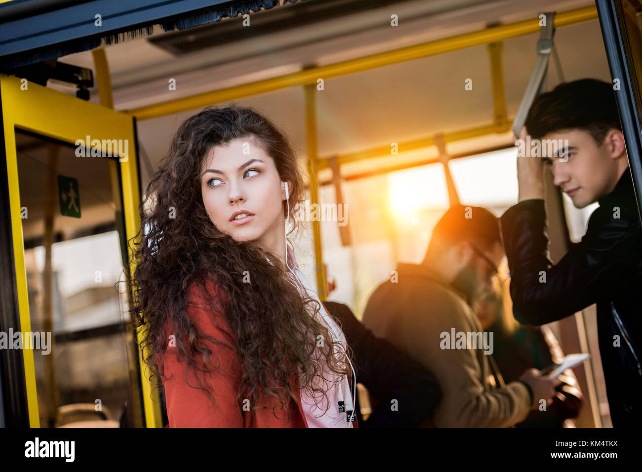 Young woman entering bus Stock Photo - Alamy