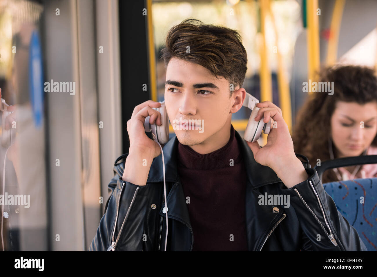 man wearing headphones in bus Stock Photo - Alamy