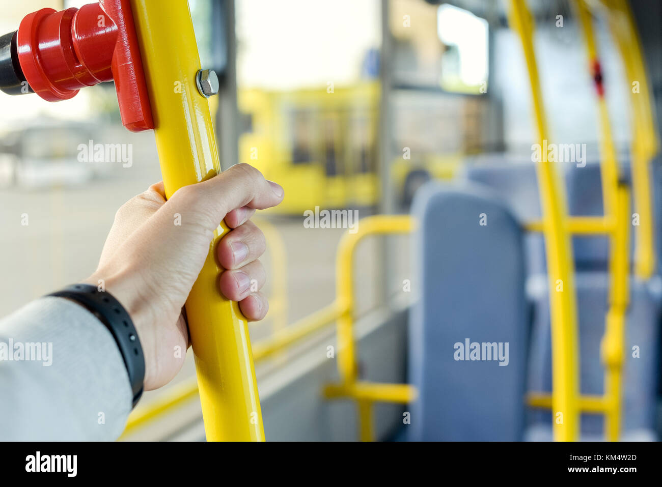 man holding bus handle Stock Photo - Alamy