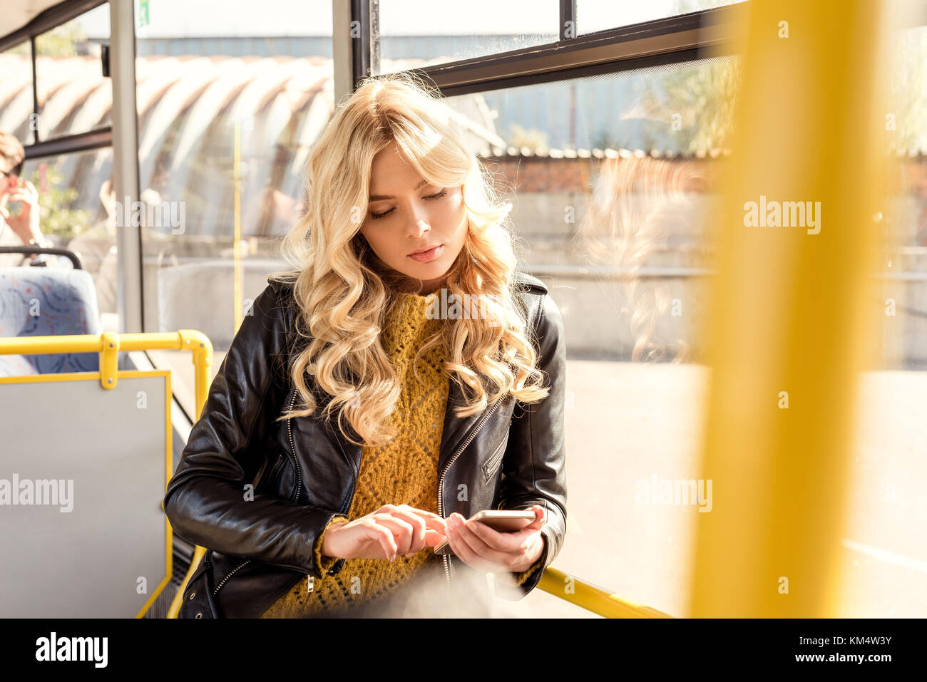 woman using smartphone in city bus Stock Photo - Alamy